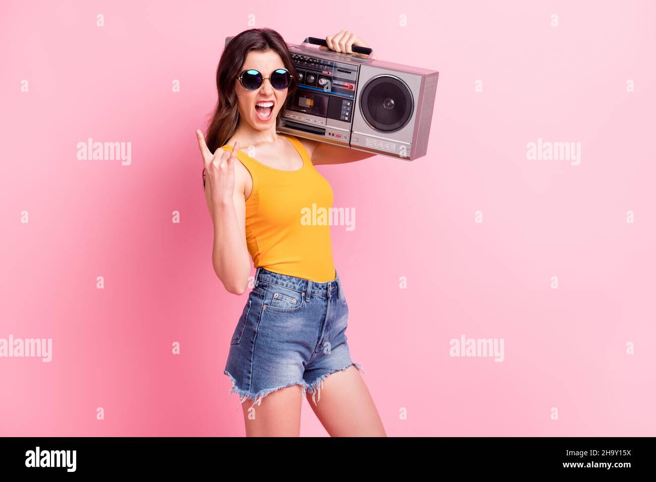 Photo of rude funky lady dressed yellow tank-top dark glasses holding ...