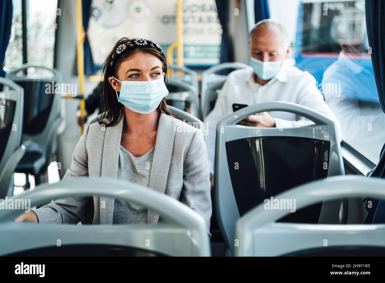 Young woman in protective mask traveling in the bus in Faro, Portugal ...