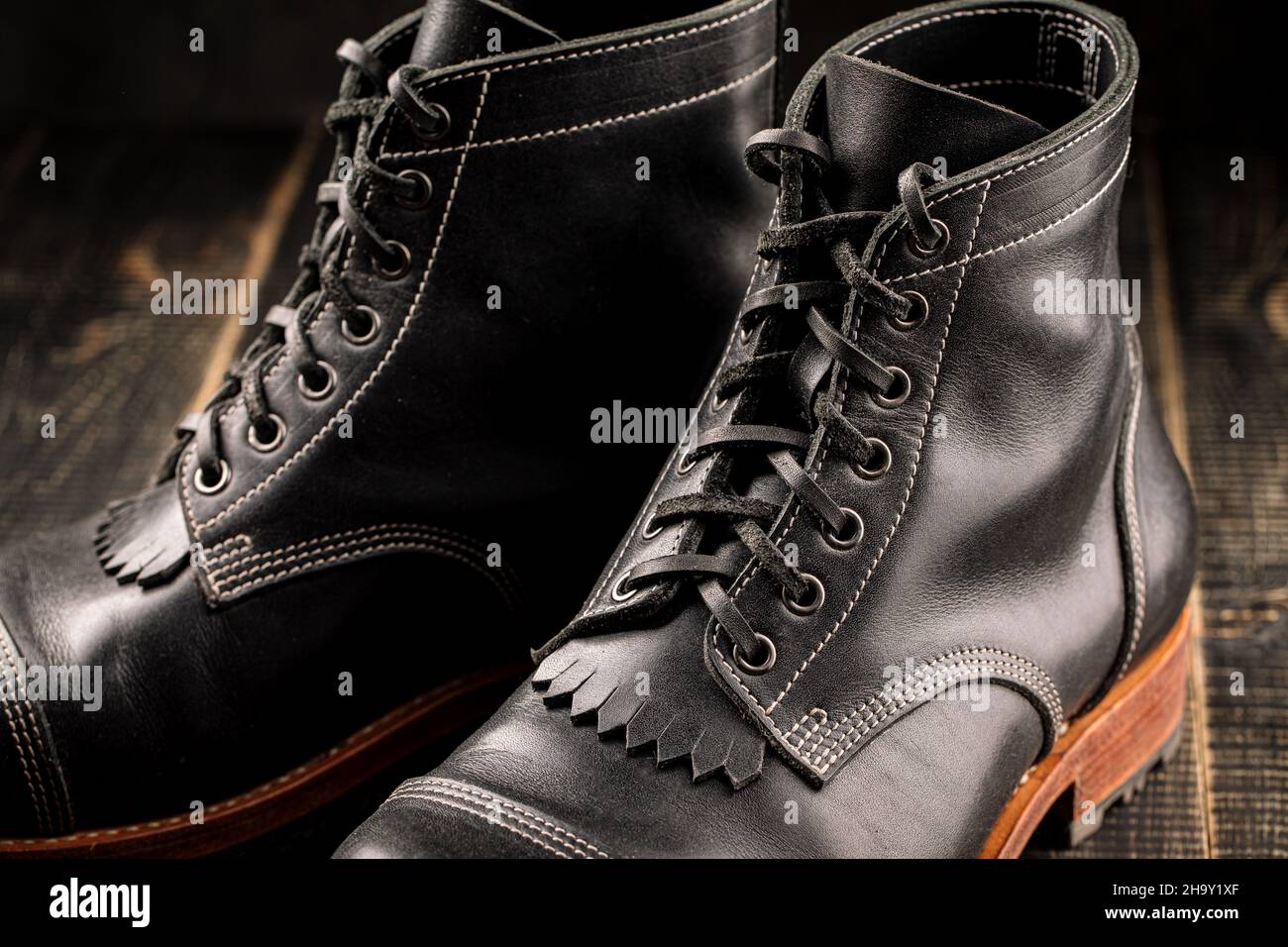 Hand crafted black leather high boots Stock Photo - Alamy