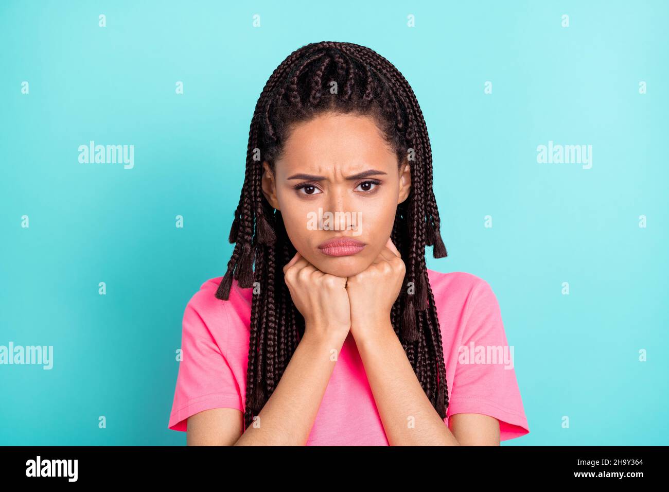 Photo of grumpy offended girl frowning grimace hands chin wear pink t ...