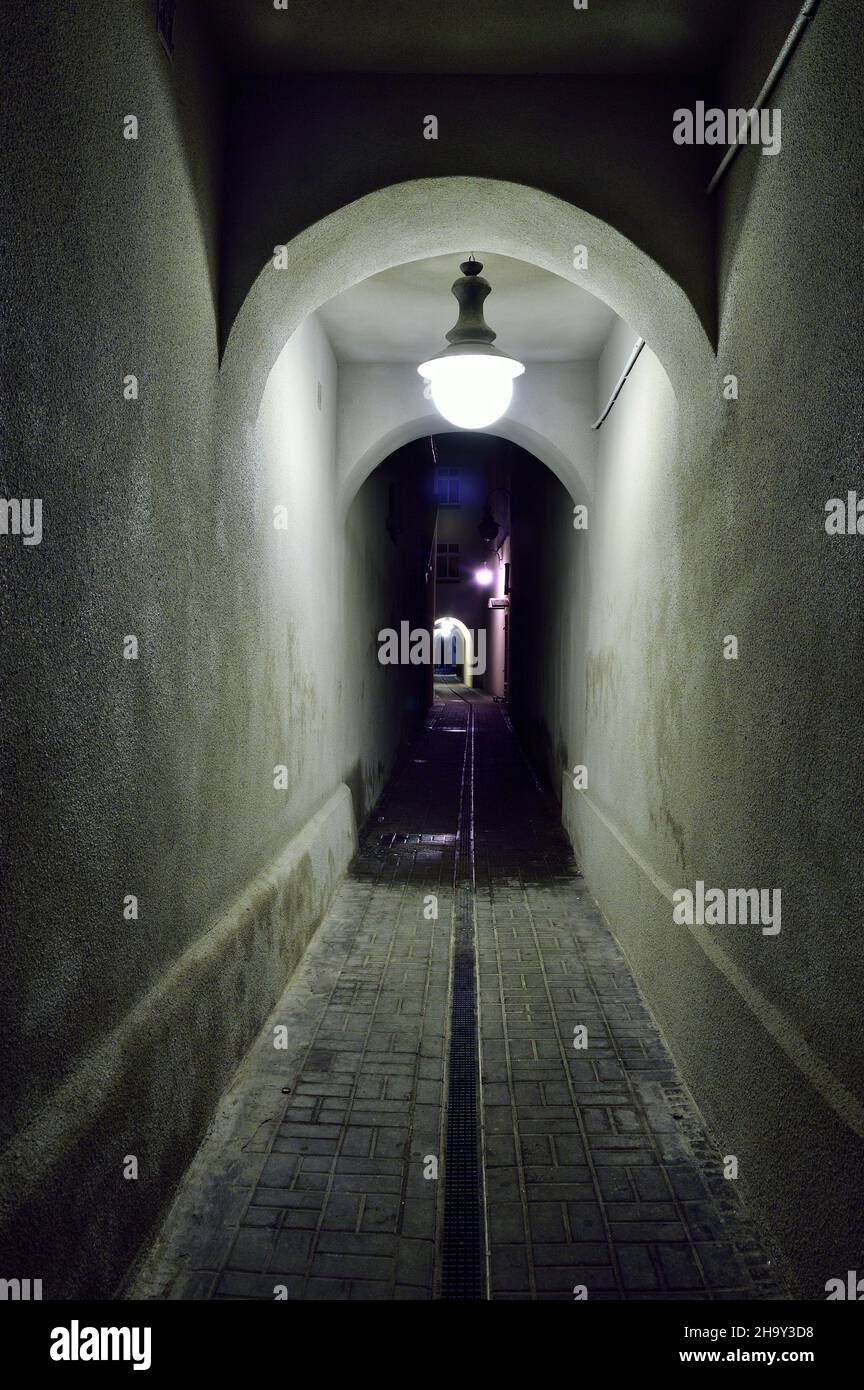 A narrow passage and an illuminating lamp in the narrow passage between ...