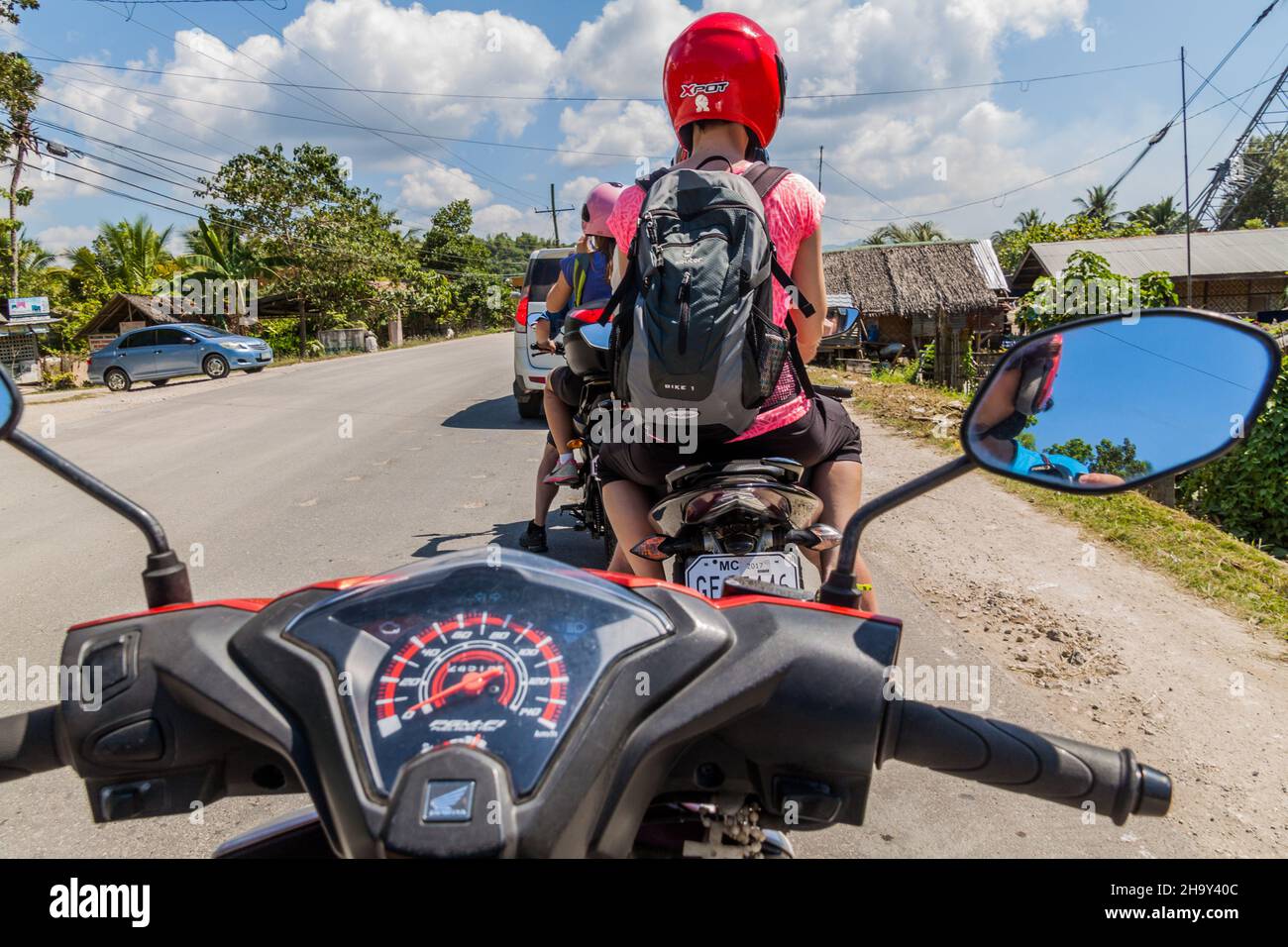 BOHOL ISLAND, PHILIPPINES - FEBRUARY 11, 2018: Riding a motorbike on a ...