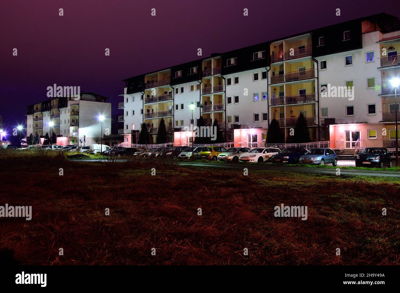 Houses and buildings illuminated with unusual light from lamps on a ...