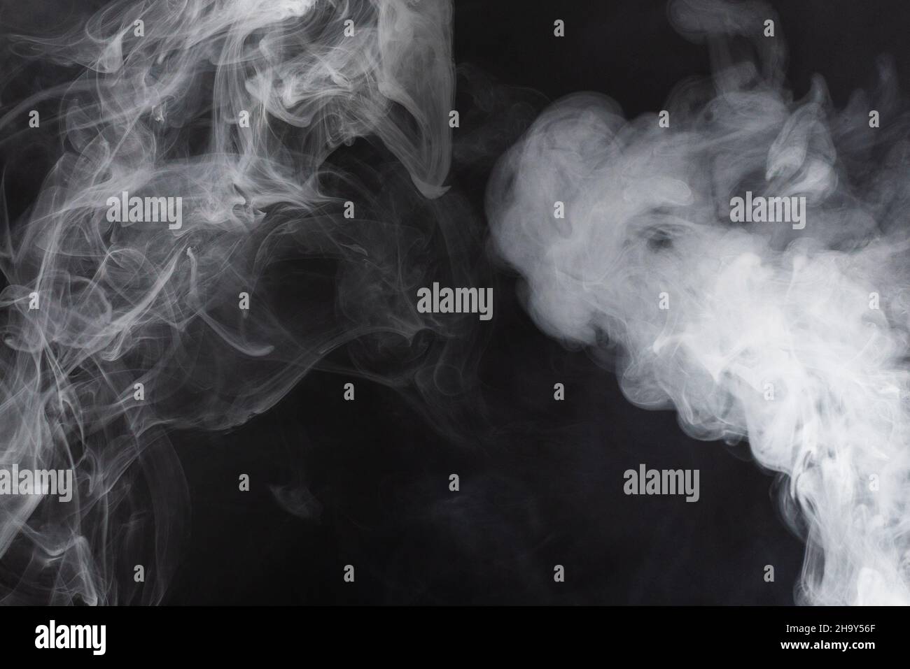 White steam on a black background. Copy space Stock Photo - Alamy