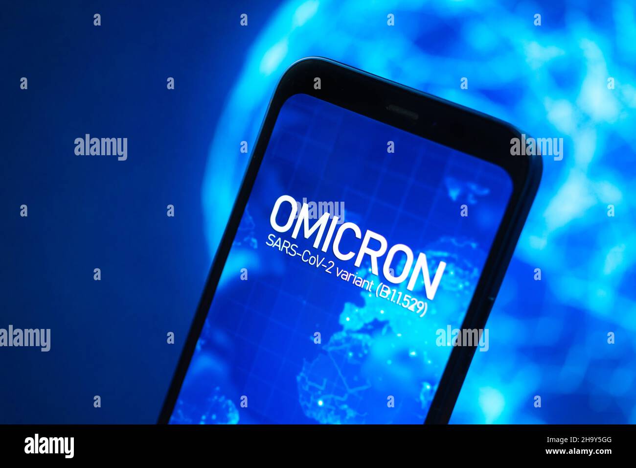 Omicron variant of coronavirus. Mobile phone with omicron text against ...