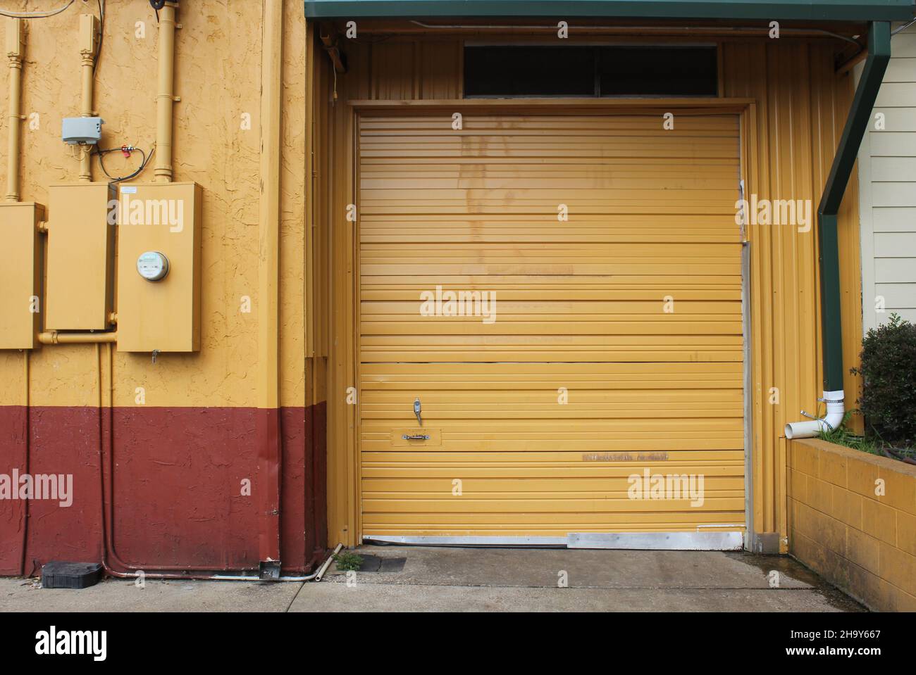 Garage Door on Warehouse and Regular Door Industrial Background Stock ...