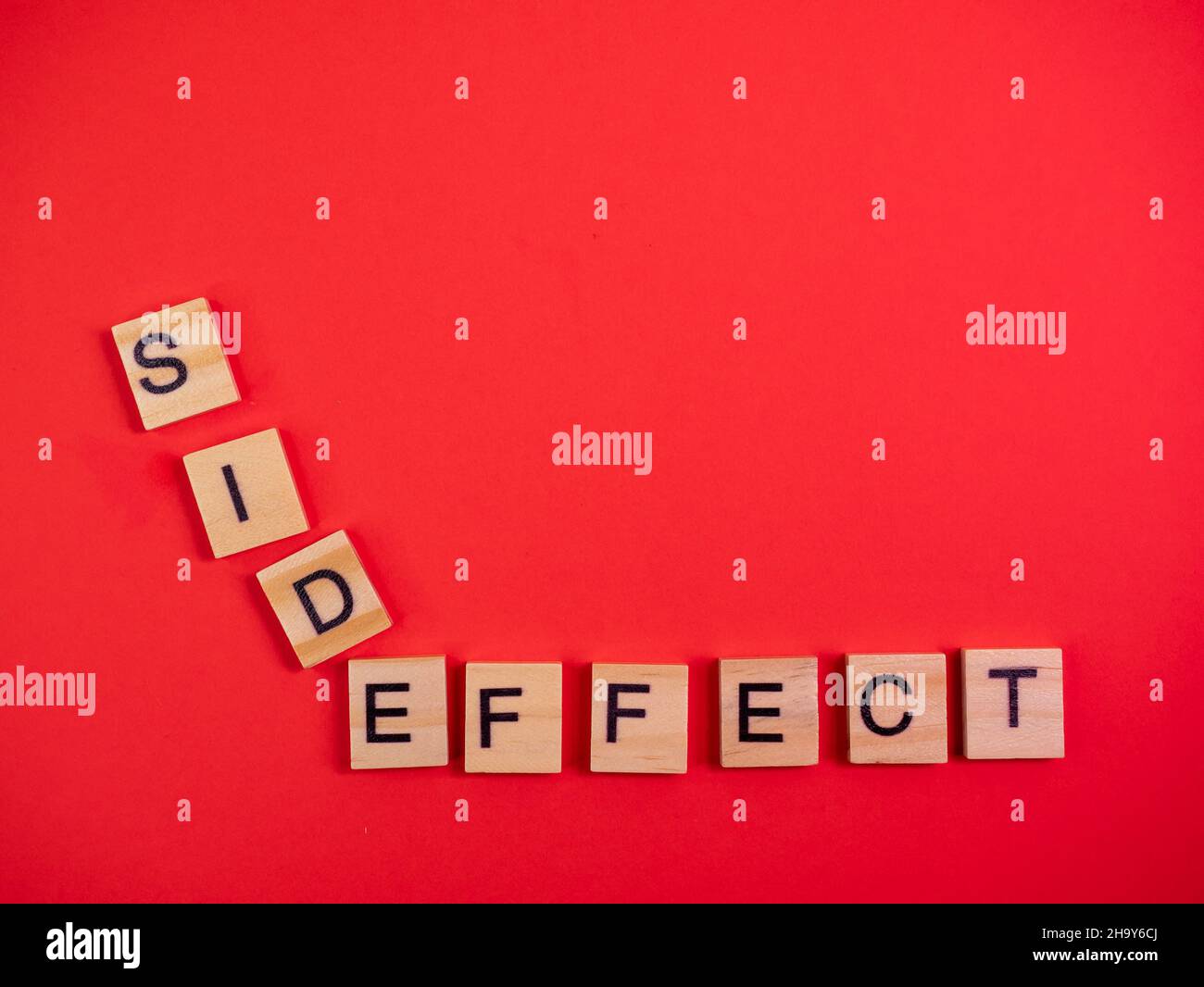 Words side effect on colored red paper texture background. Concept ...