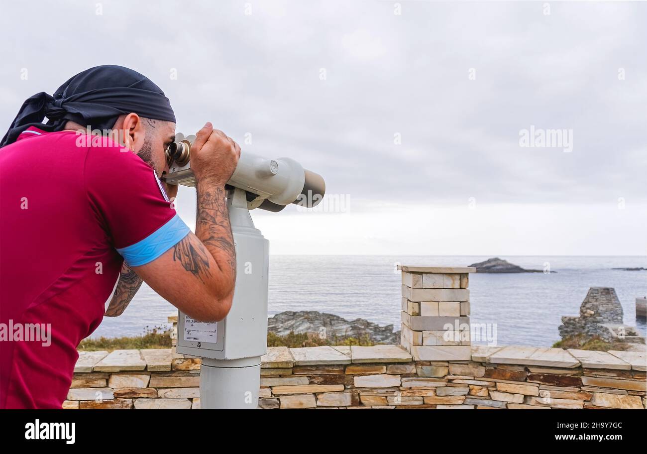 Pirate with beard and tattoos looking through binoculars Stock Photo ...