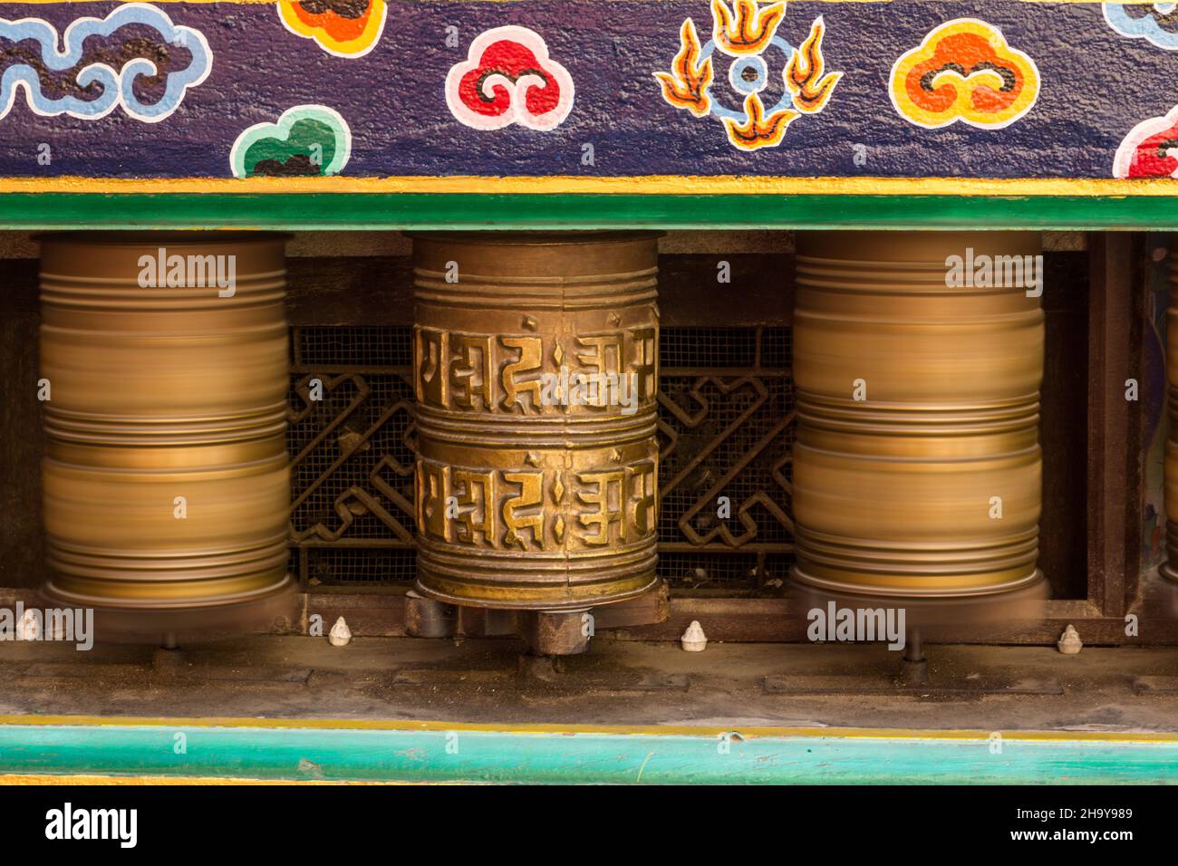Spinning Tibetan-style prayer wheels or mani wheels at the Buddhist ...