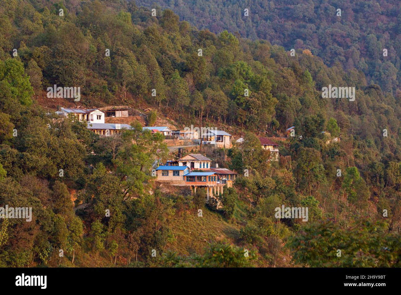 Traditional farm houses on a steep hillside near the Himalayan foothill ...