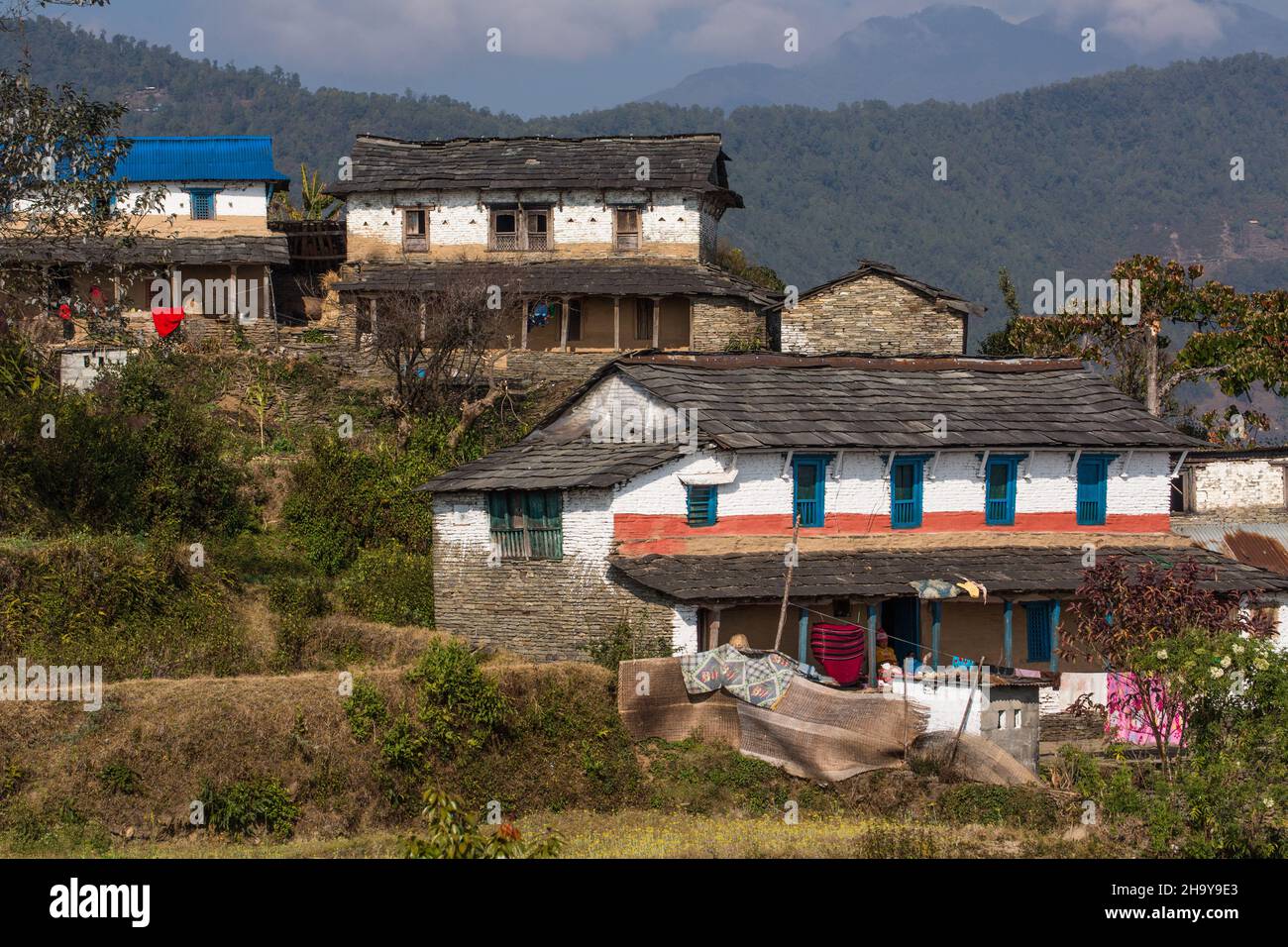 Traditional stone farm houses with slate tile roofs in the Himalayan ...