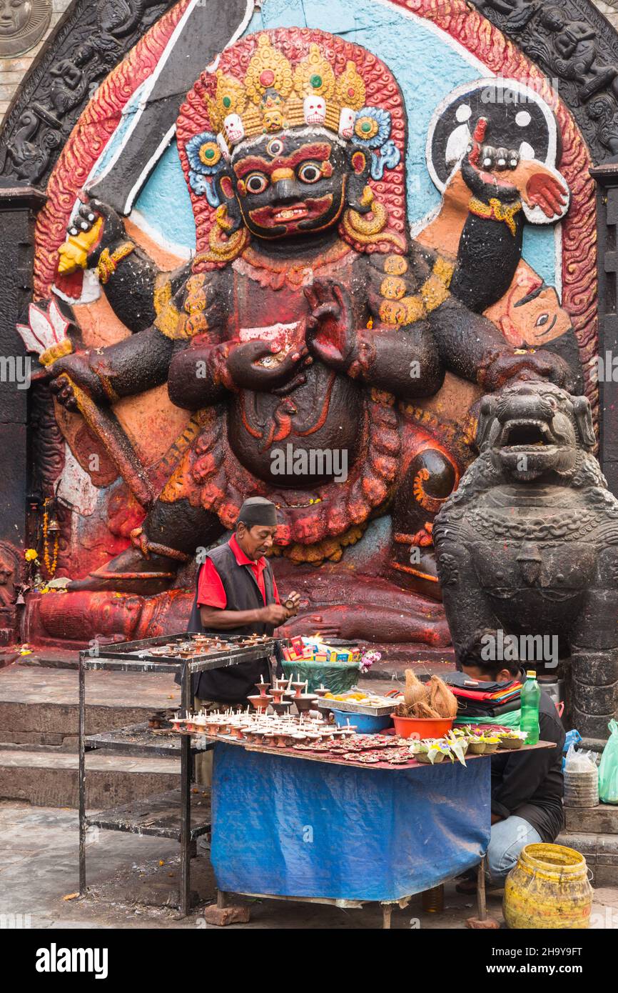 A vendors sells offerings at the Hindu shrine of the Kala or Black ...