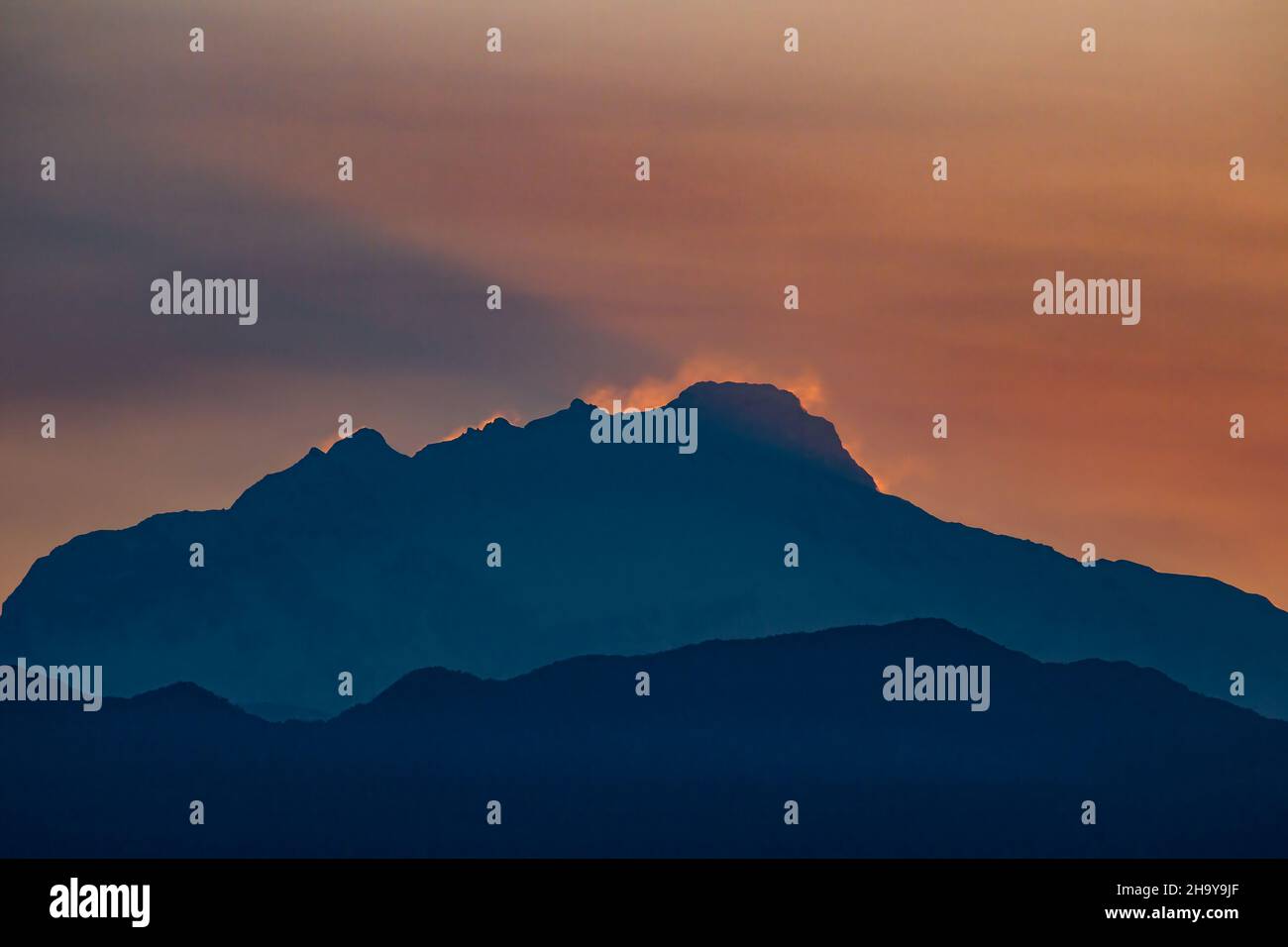 Clouds of spindrift snow blowing off a peak in the Mansiri Himal ...
