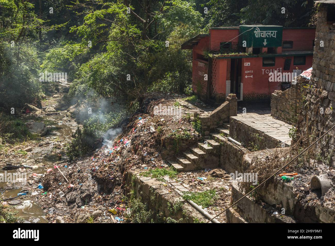 Debris and trash polluting the stream by the Dakshinkali Temple, a ...