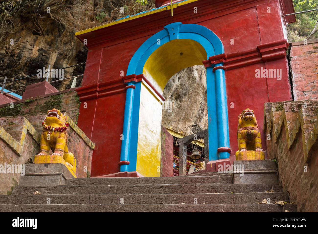 Temple lions guard the arched entryway to the Shesh Narayan Temple, a ...