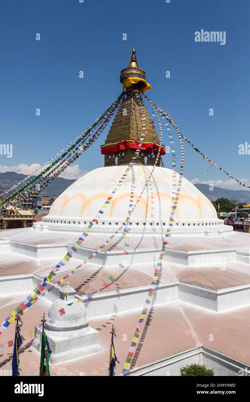 The dome, harmika and spire of the Boudhanath Stupa with prayer flags ...