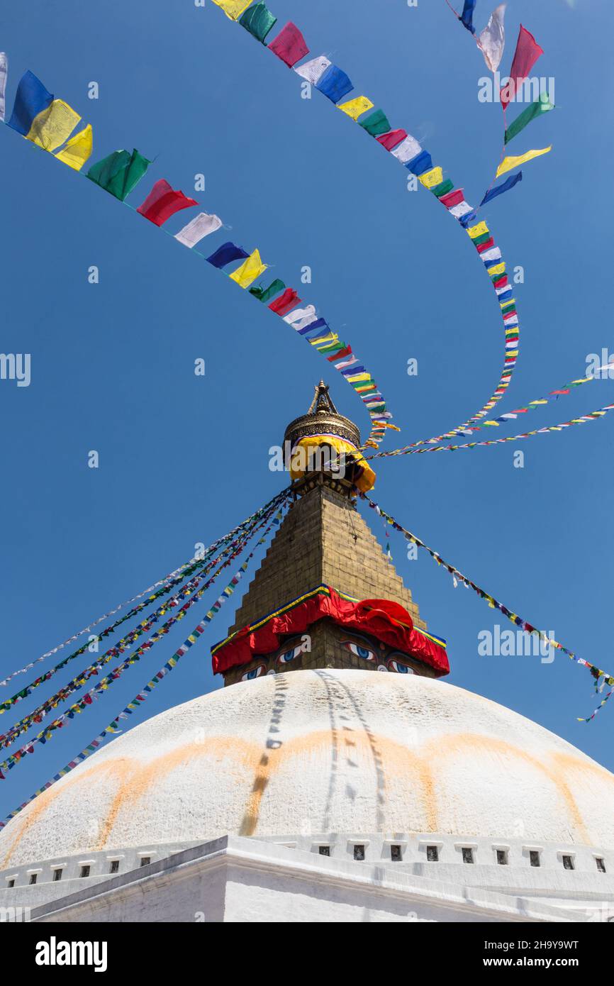 The dome, harmika and spire of the Boudhanath Stupa with prayer flags ...