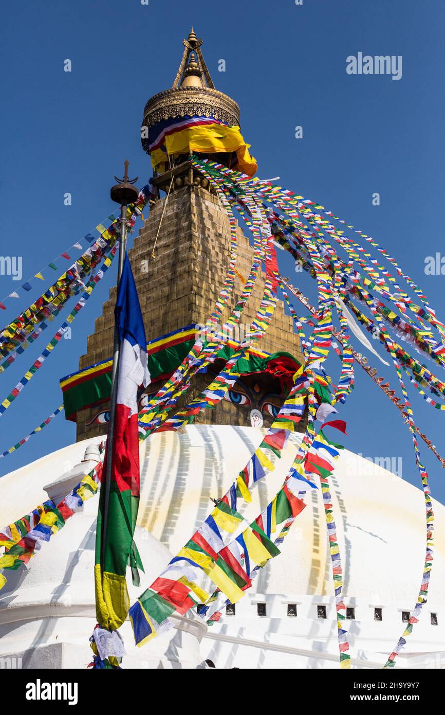 The dome, harmika and spire of the Boudhanath Stupa with prayer flags ...