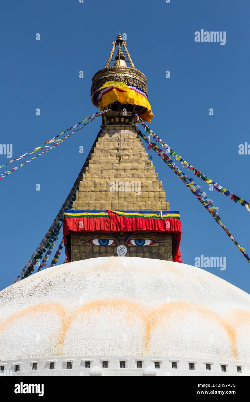 The dome, harmika and spire of the Boudhanath Stupa with prayer flags ...