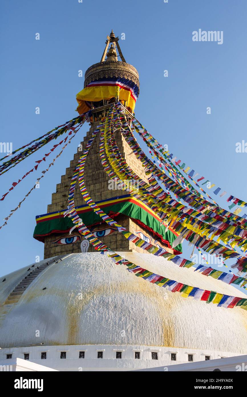 The dome, harmika and spire of the Boudhanath Stupa with prayer flags ...