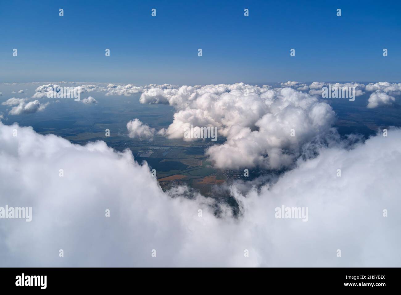 Aerial view from airplane window at high altitude of earth covered with ...