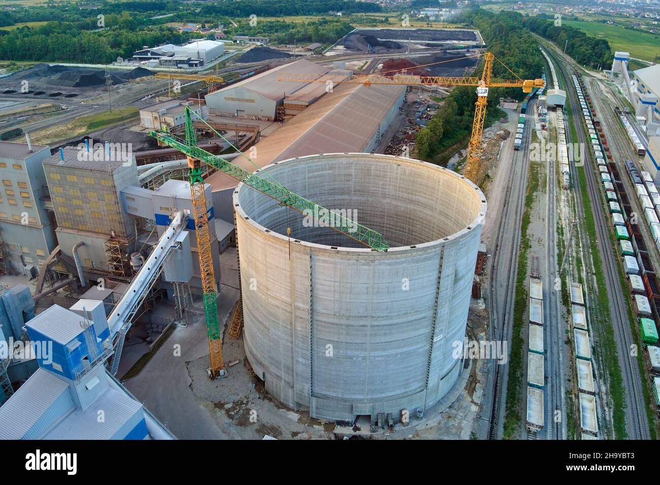 Aerial view of cement factory under construction with high concrete ...