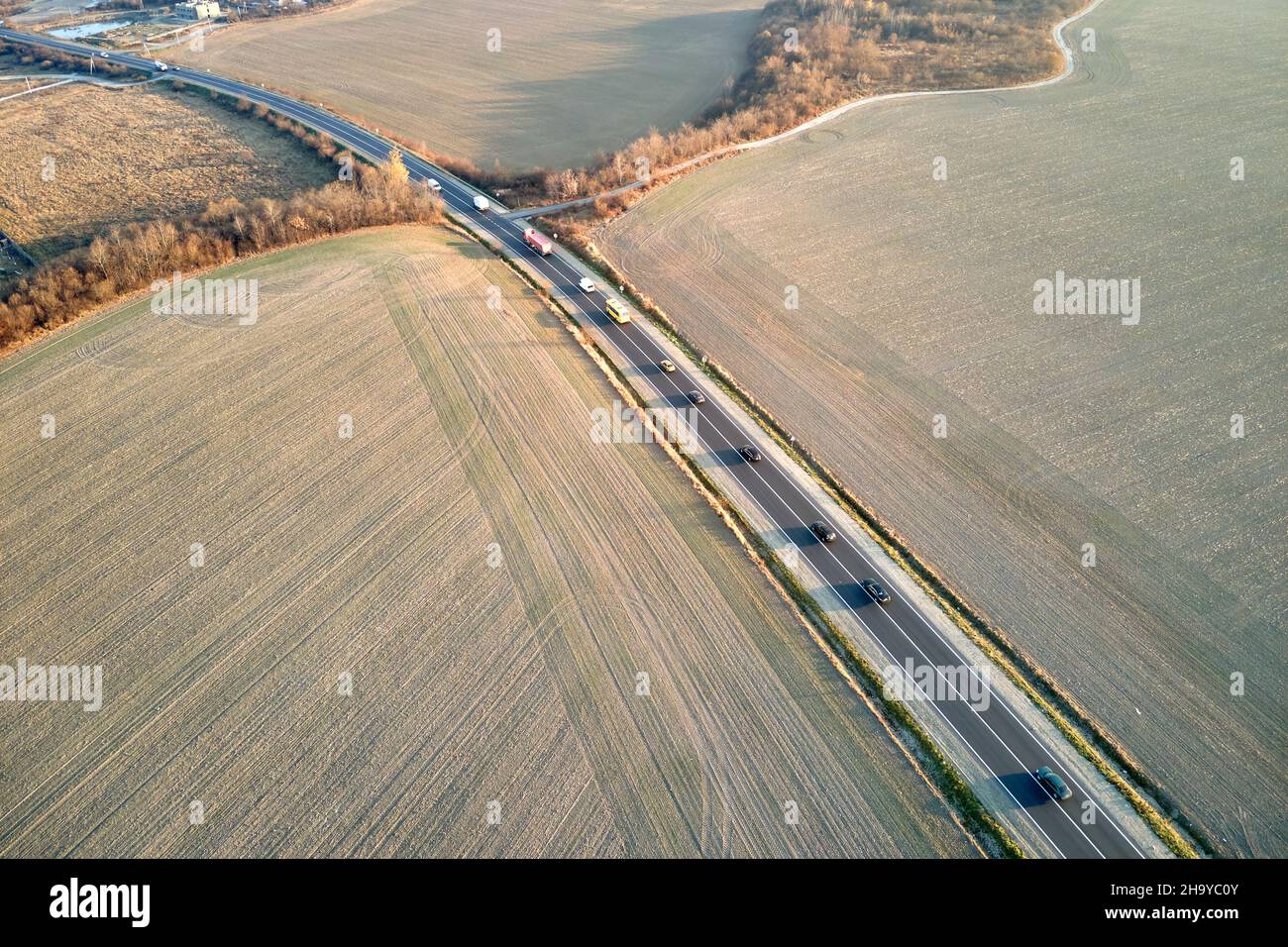 Aerial view of intercity road with fast driving cars at sunset. Top ...