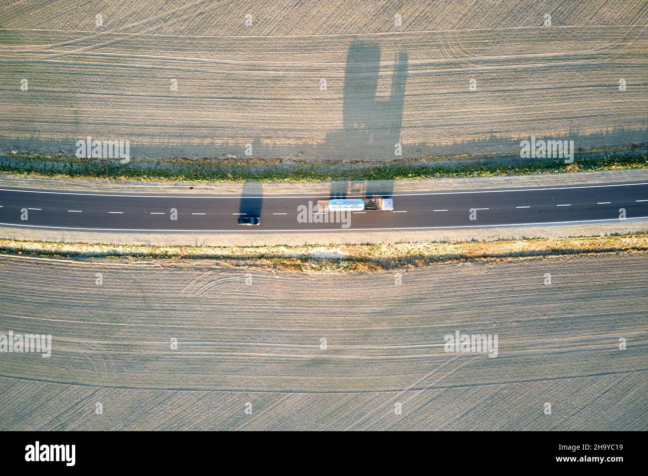 Aerial view of intercity road with fast driving cars at sunset. Top ...