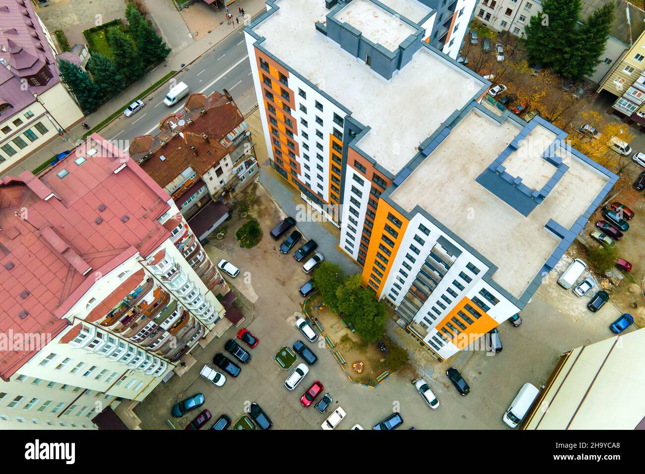 Aerial view of parked cars on parking lot between high apartment ...