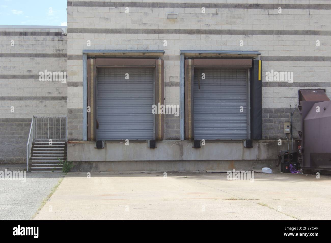Garage Door on Warehouse and Regular Door Industrial Background Stock ...