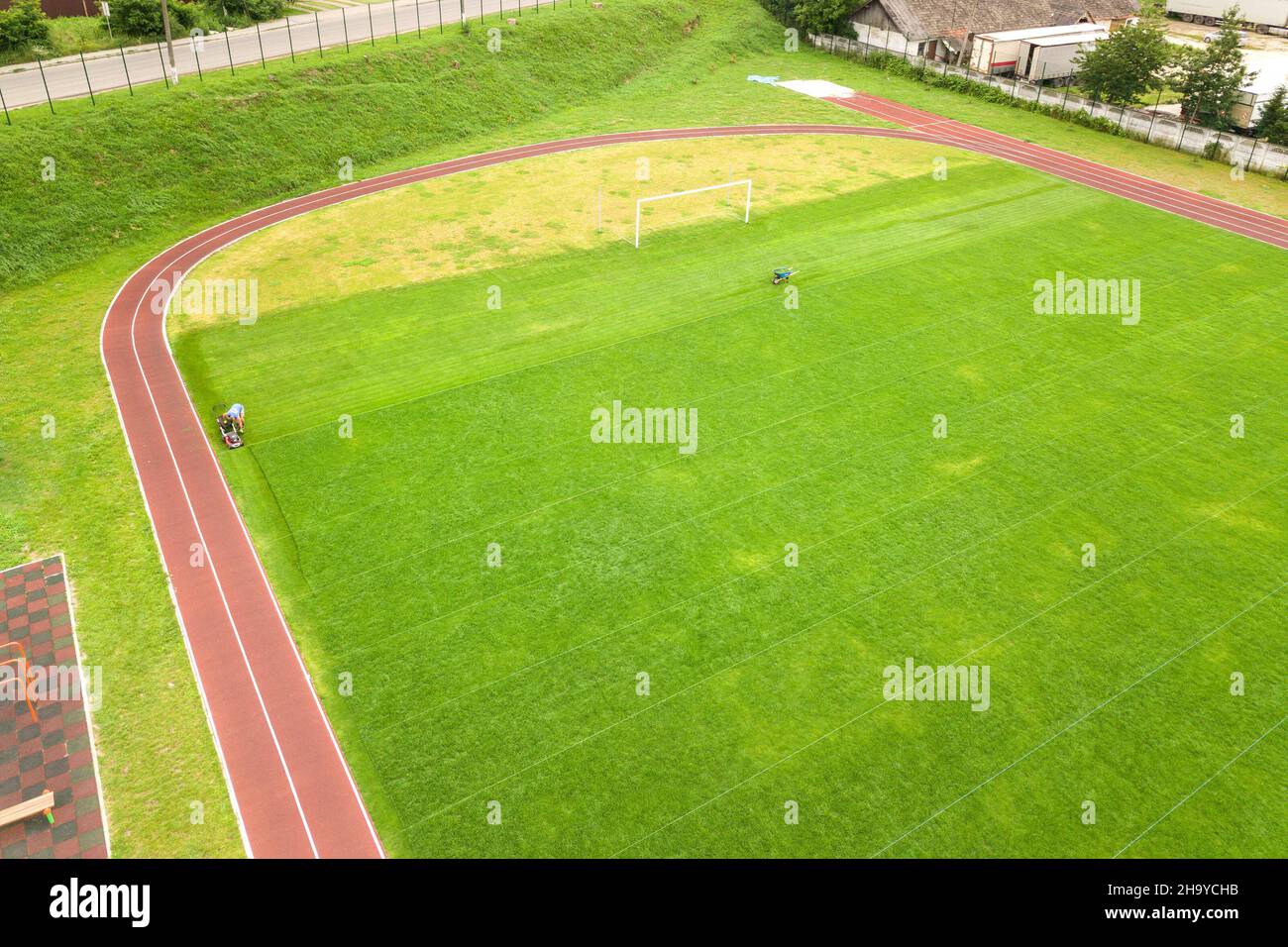 Aerial view of sports stadium with red running tracks and green grass ...