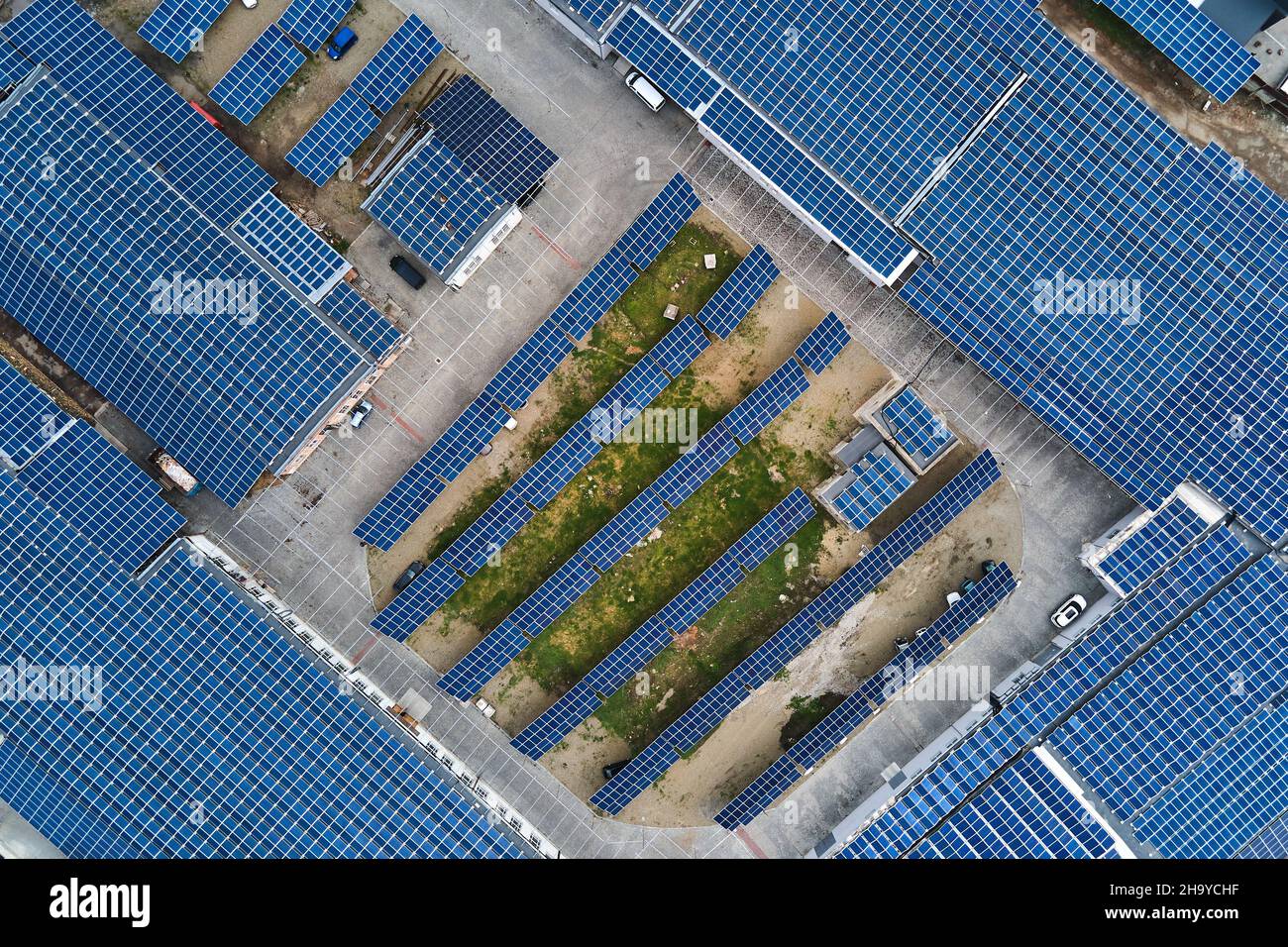 Aerial view of solar power plant with blue photovoltaic panels mounted ...