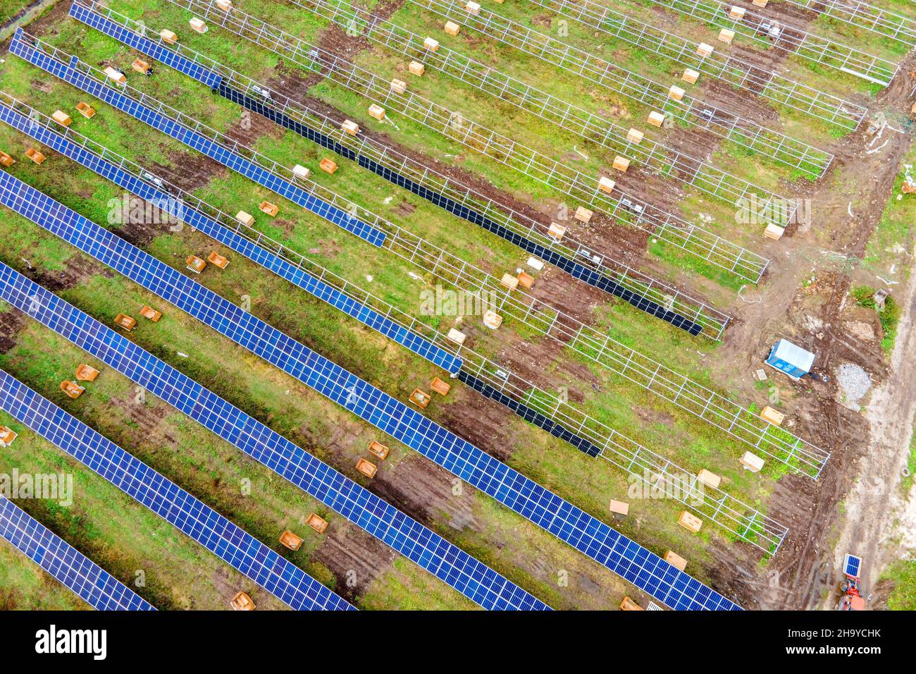 Aerial view of solar power plant under construction on green field ...