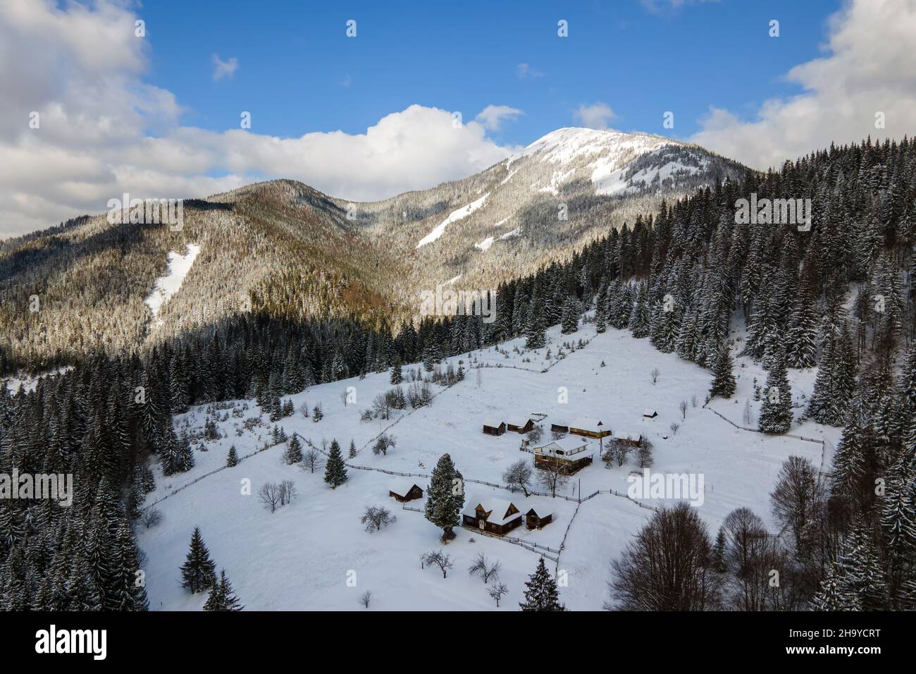 Aerial winter landscape with small rural houses between snow covered ...