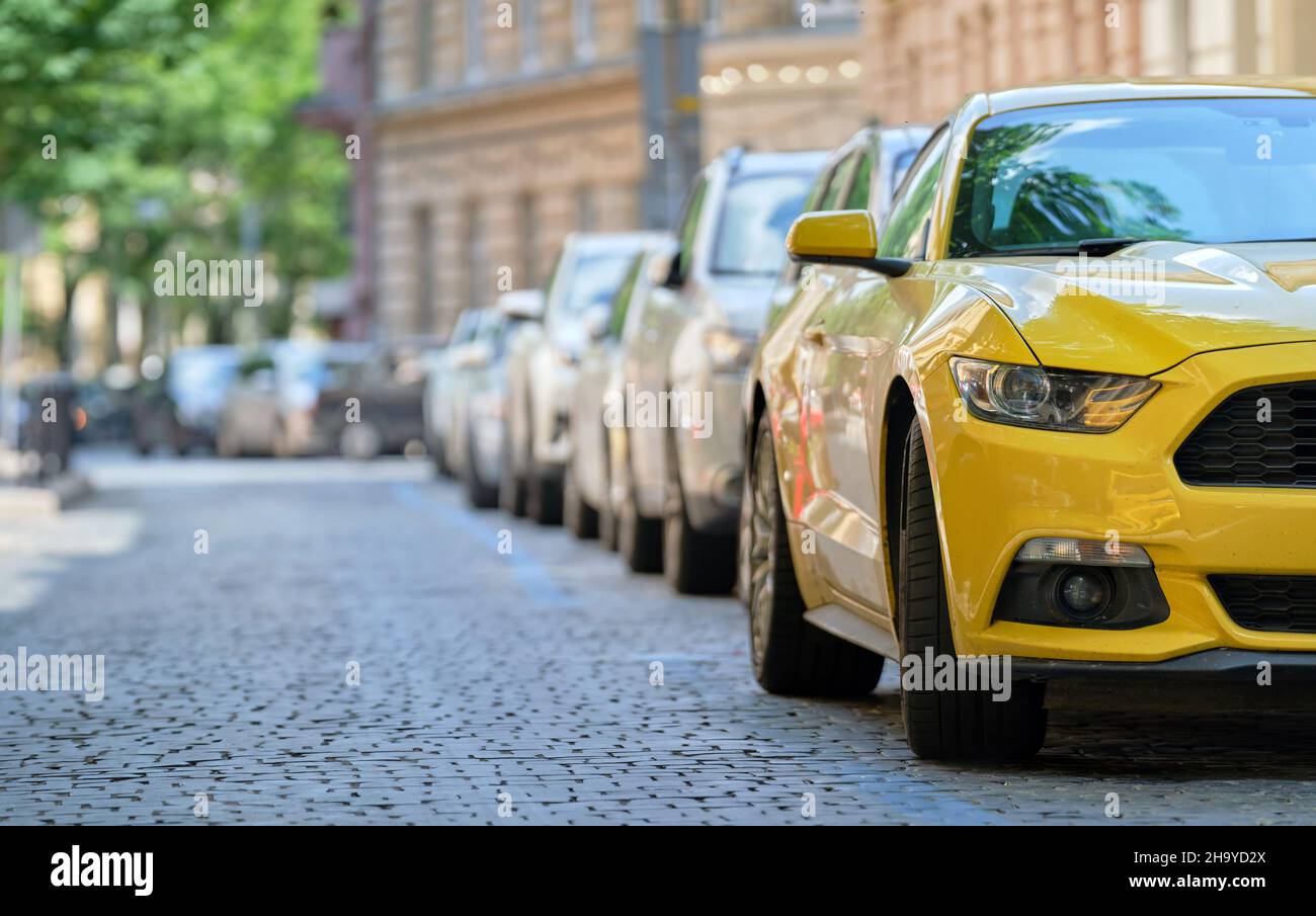 City traffic with cars parked in line on street side Stock Photo - Alamy