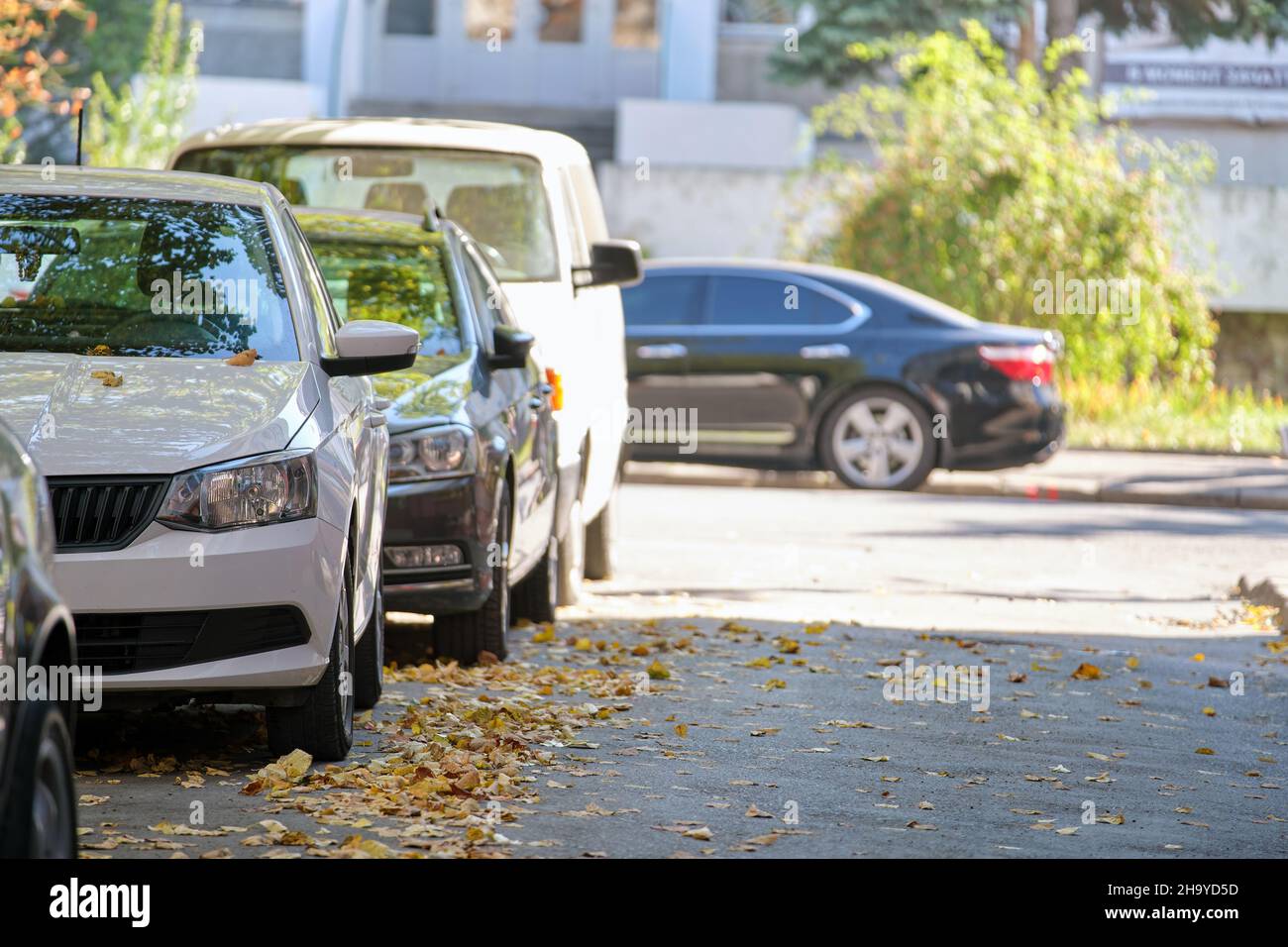 City traffic with many cars parked in line on street side Stock Photo ...