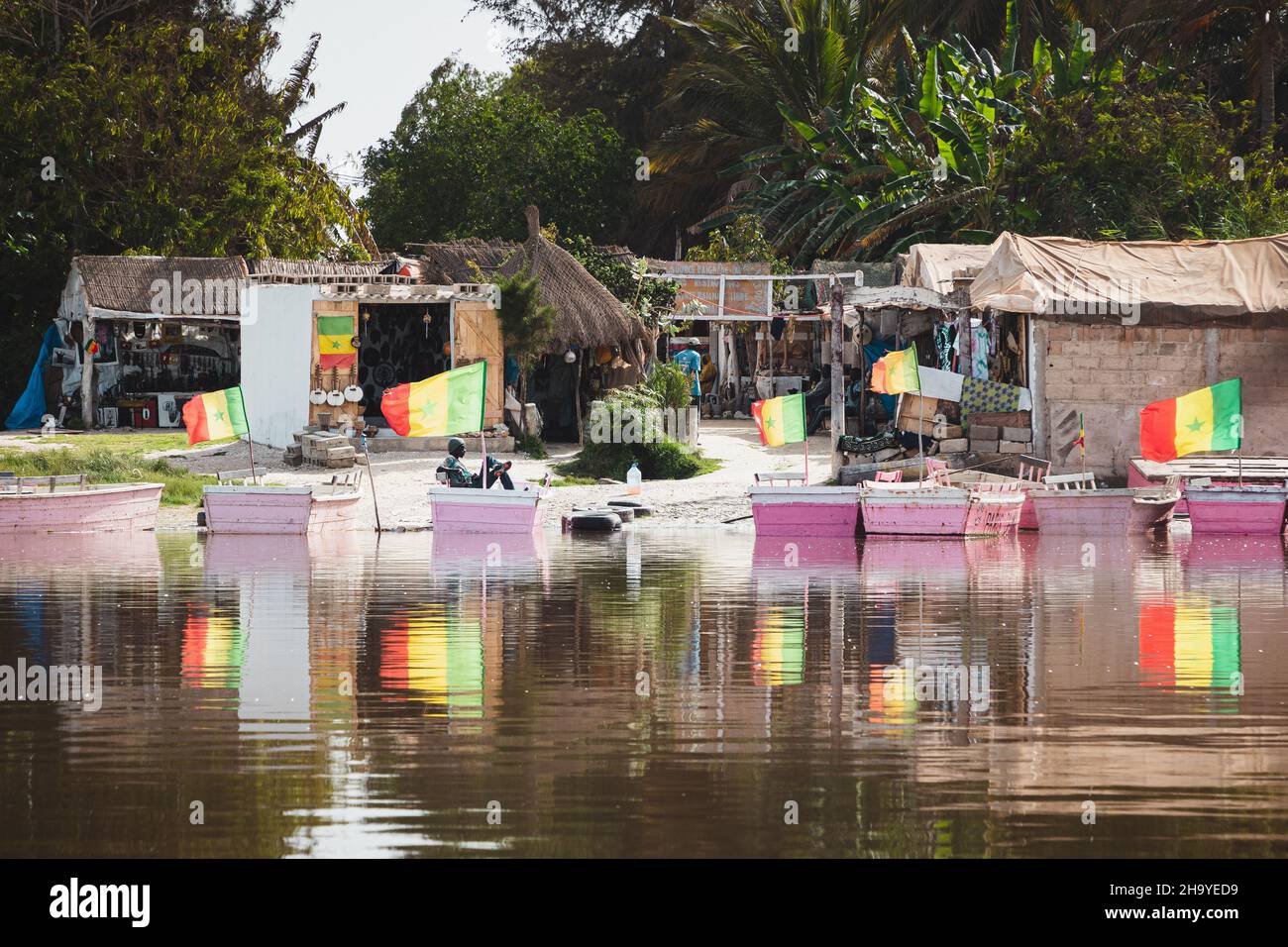 Boat tour on Lac Rose (Pink Lake) near Dakar. The water of the lake has ...
