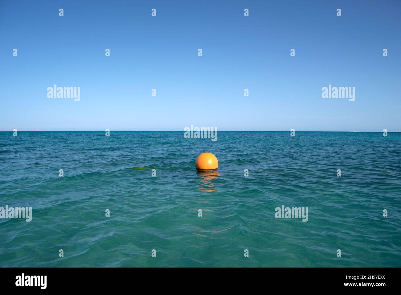 Orange buoy floating on sea surface waves. Human life safety concept ...