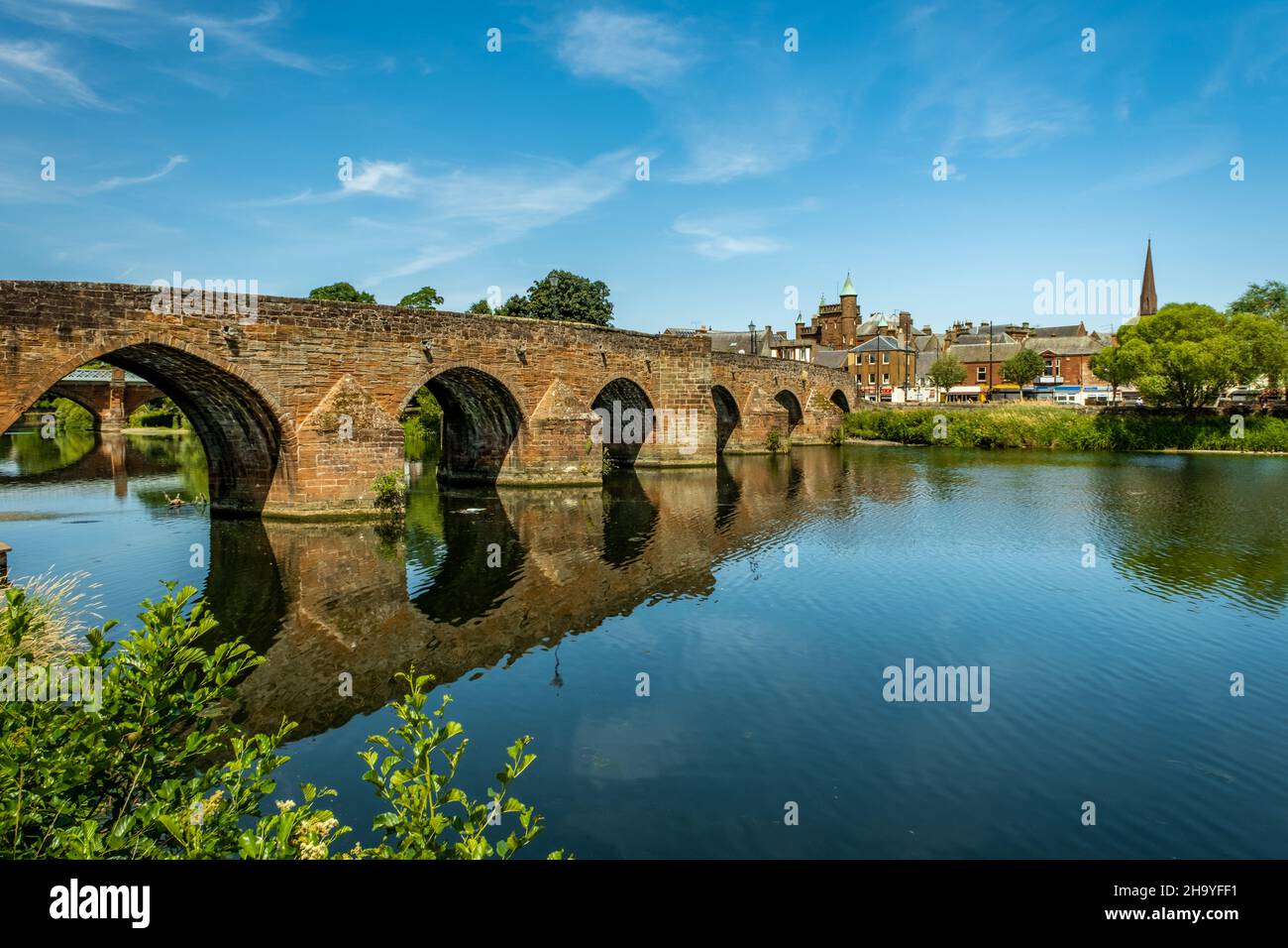 The Medieval Devorgilla Bridge with its gothic arches, reflecting on ...