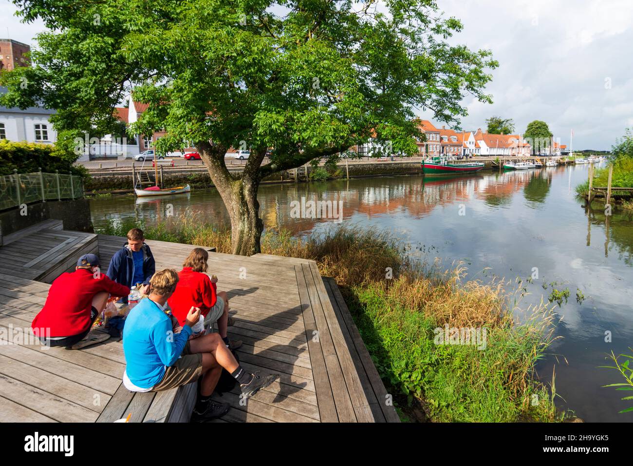 Esbjerg: river Ribe, tourists at picnic, old harbor, historic ships ...