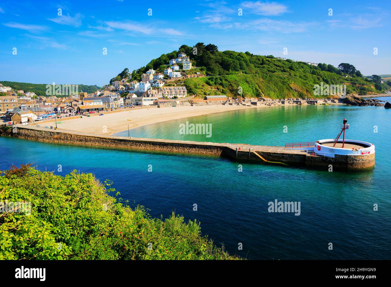 Looe Cornwall beach and harbour wall with beautiful blue sea and sky ...