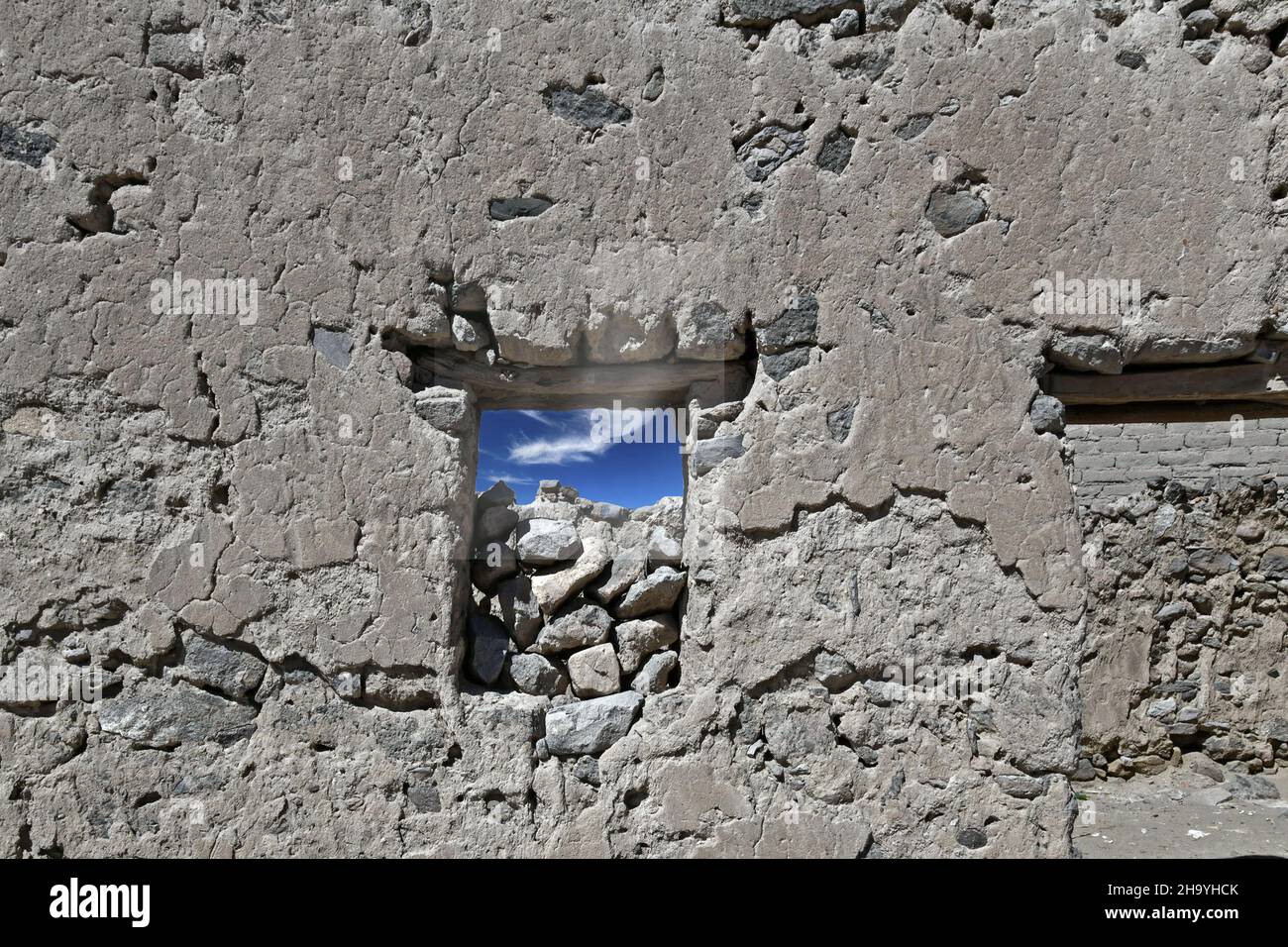 Old building wall with a small window hole in the northern part of ...