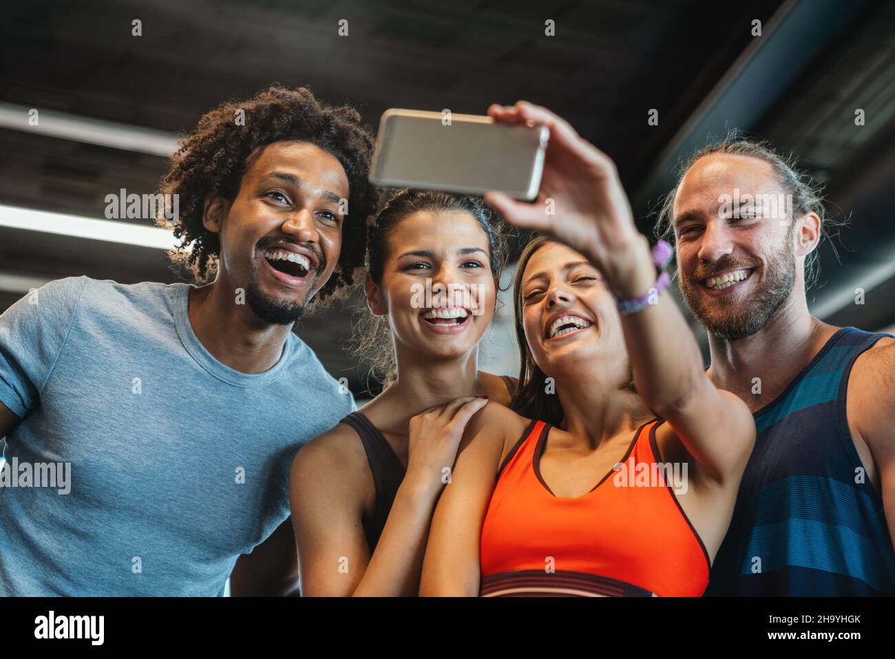 Group of sportive people in a gym having fun, taking selfie Stock Photo ...