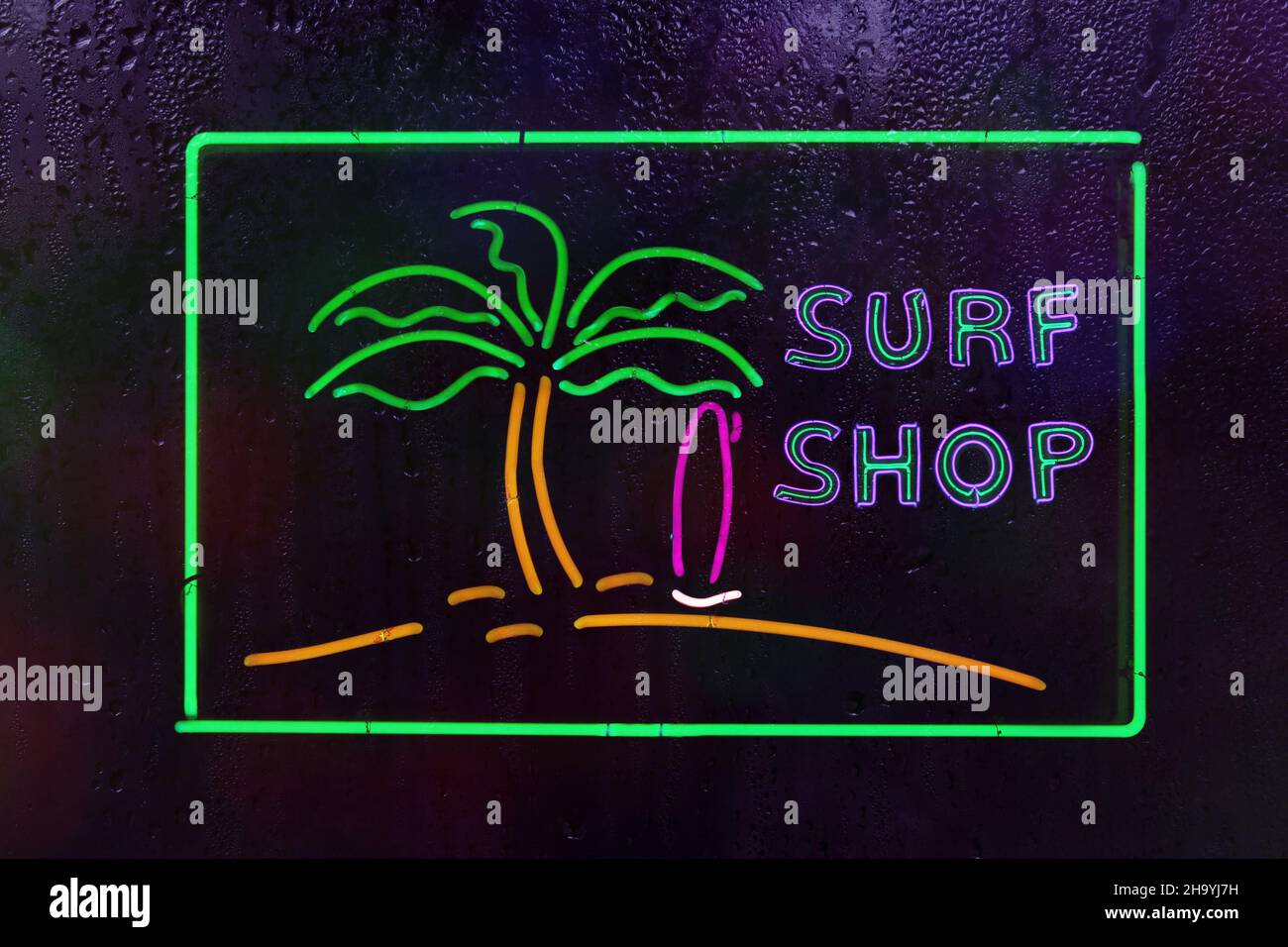 Neon Surf Shop Sign in Rainy Window Stock Photo - Alamy