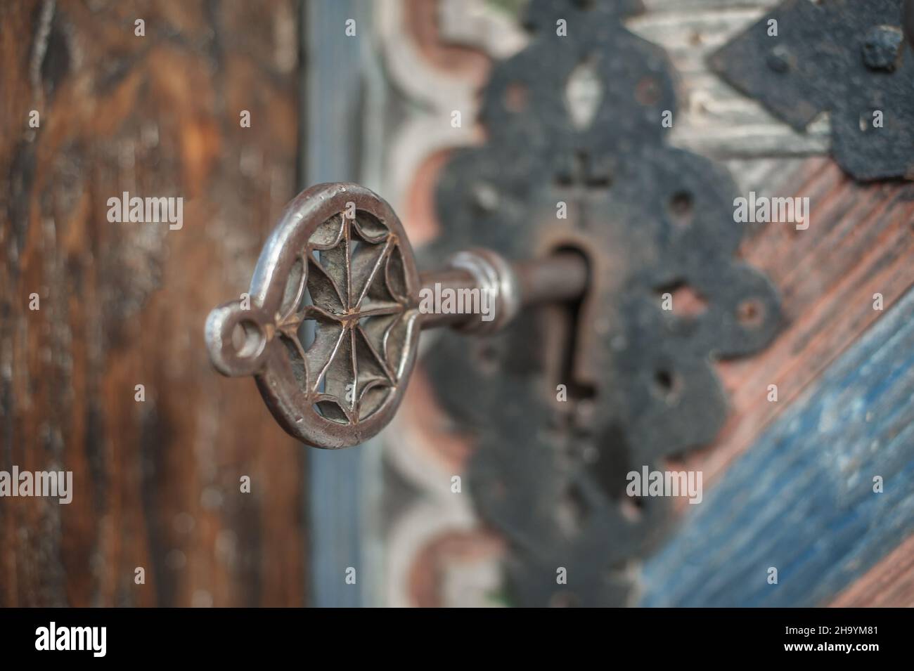 Closeup detail view of old massive metal key in a large huge church ...