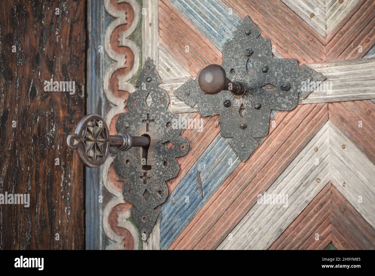 Closeup detail view of old massive metal key in a large huge church ...