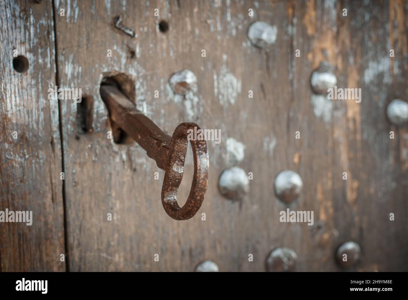 Closeup detail view of old massive metal key in a large huge church ...
