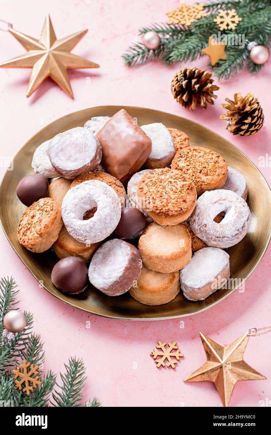 Holiday delicacies polvorones and mantecados in golden plate on pink ...