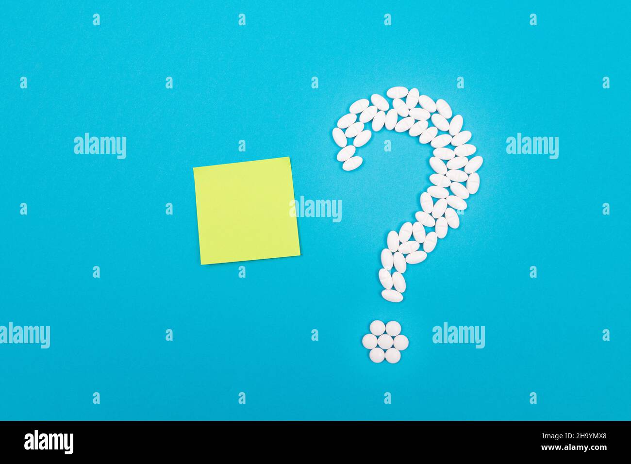 Question Mark Made from White Pills and Tablets with Small Blank Memo ...