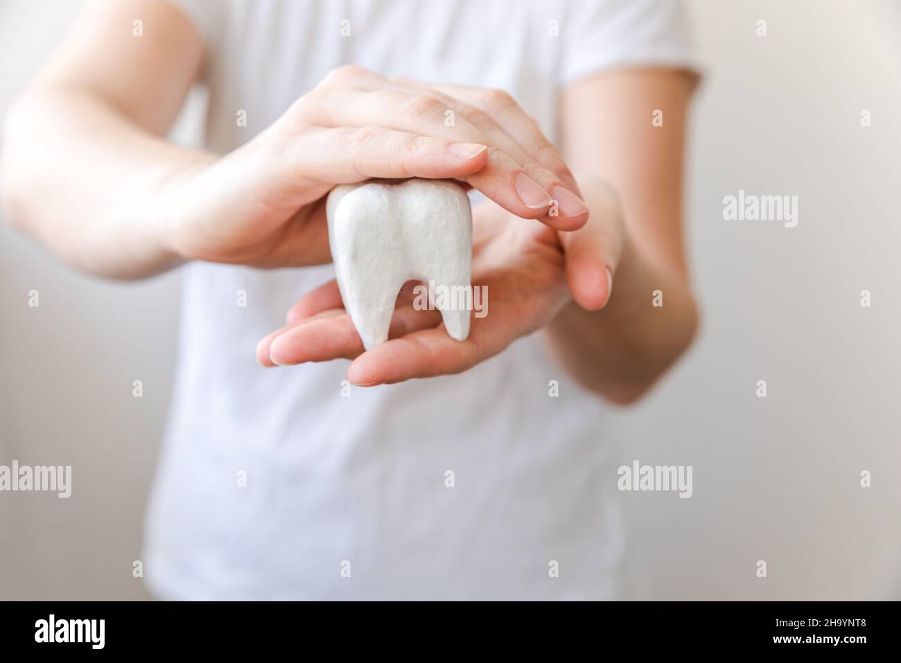 Health dental care concept. Woman hand holding white healthy tooth ...